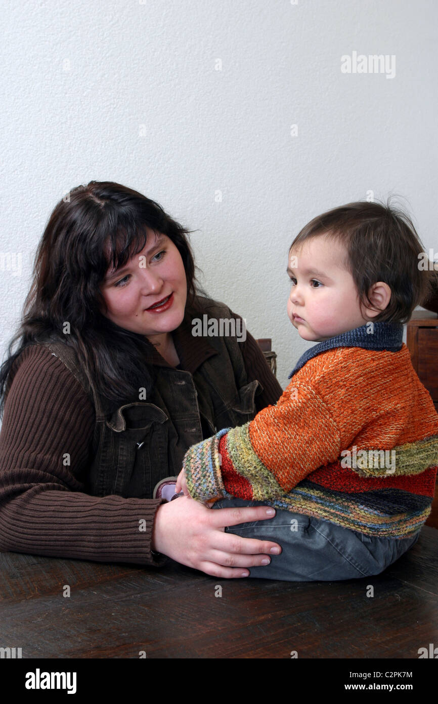 Teenage plus sized mum looking at her obese baby Stock Photo - Alamy