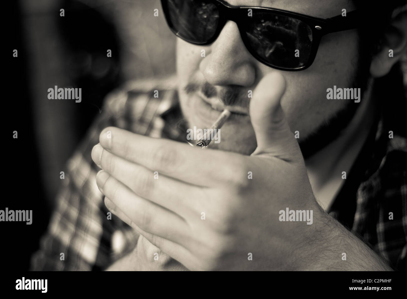 A man smoking a roll up cigarette Stock Photo - Alamy
