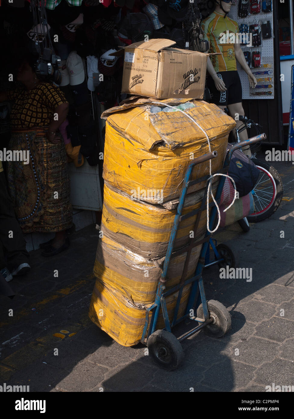 A stack of goods to be delivered to a vendor's stall stills on a two ...