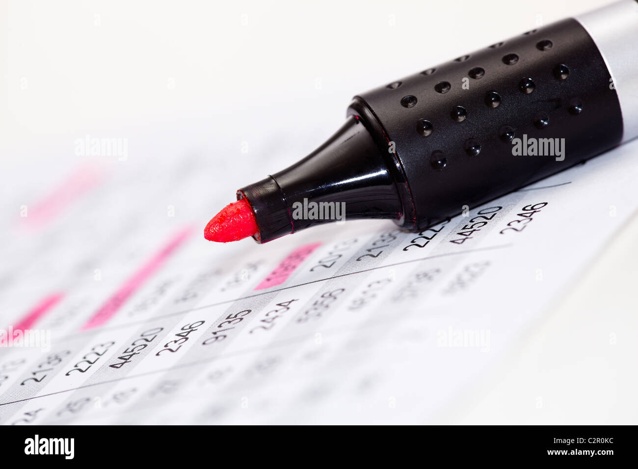Part of red highlighter on document at workplace Stock Photo - Alamy