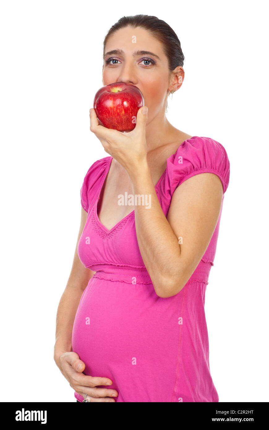 Pregnant eating red big apple and holding her tummy isolated on white ...