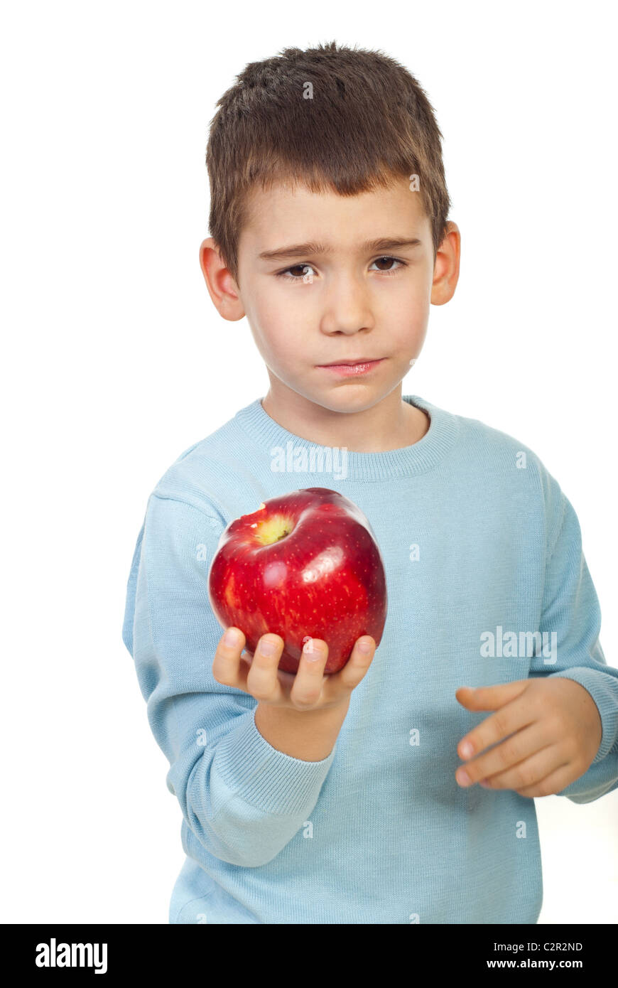 Little boy holding and apple and looks tired of to much eating apples ...