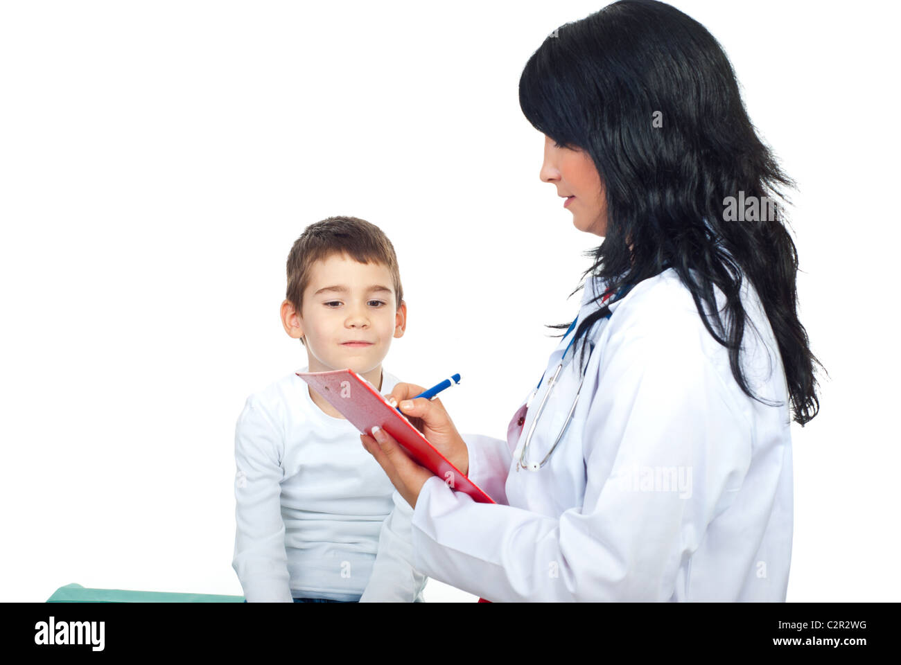 Doctor questioning boy and writing in clipboard isolated on white ...