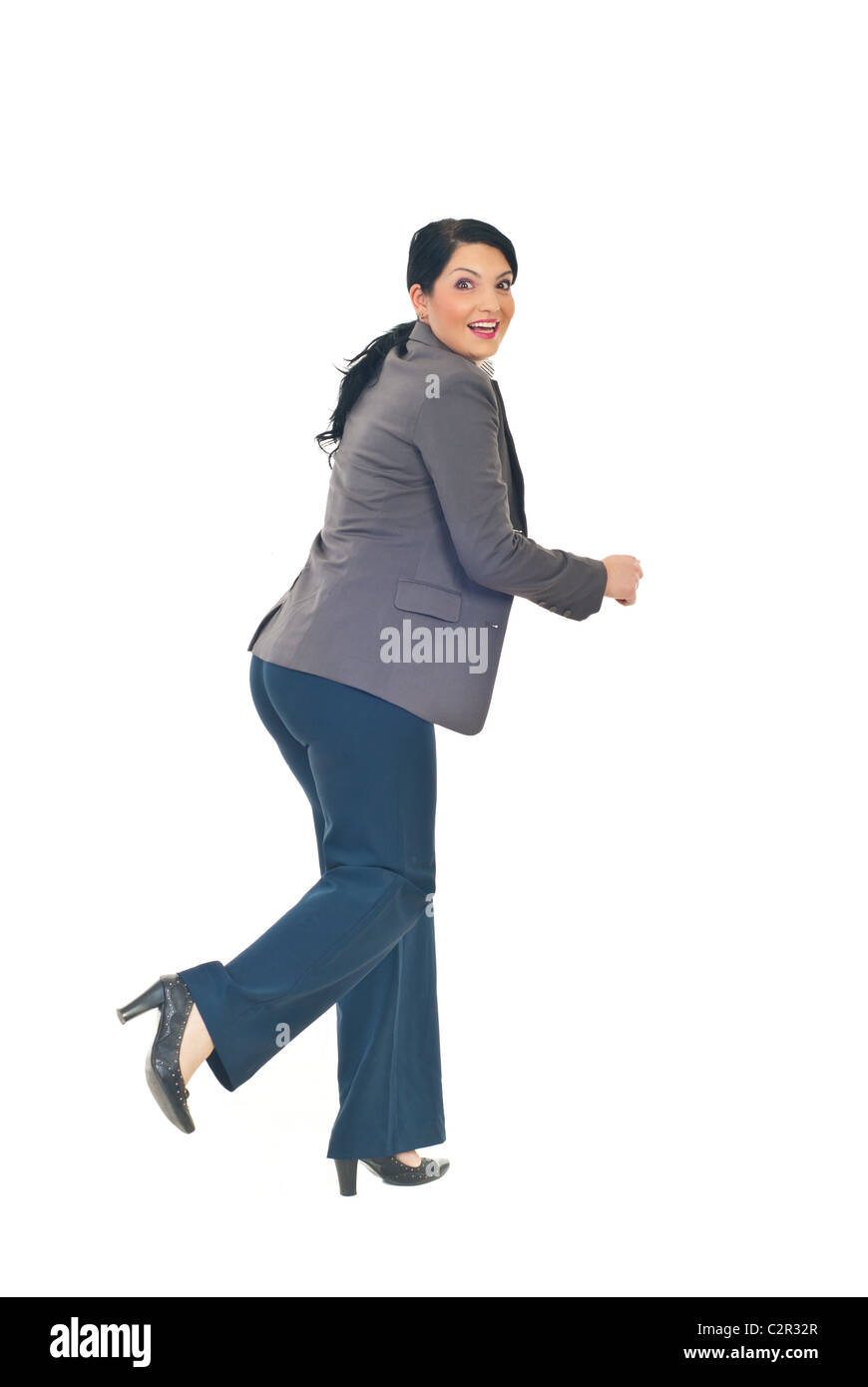 Full length of business woman running from something and looking back ...