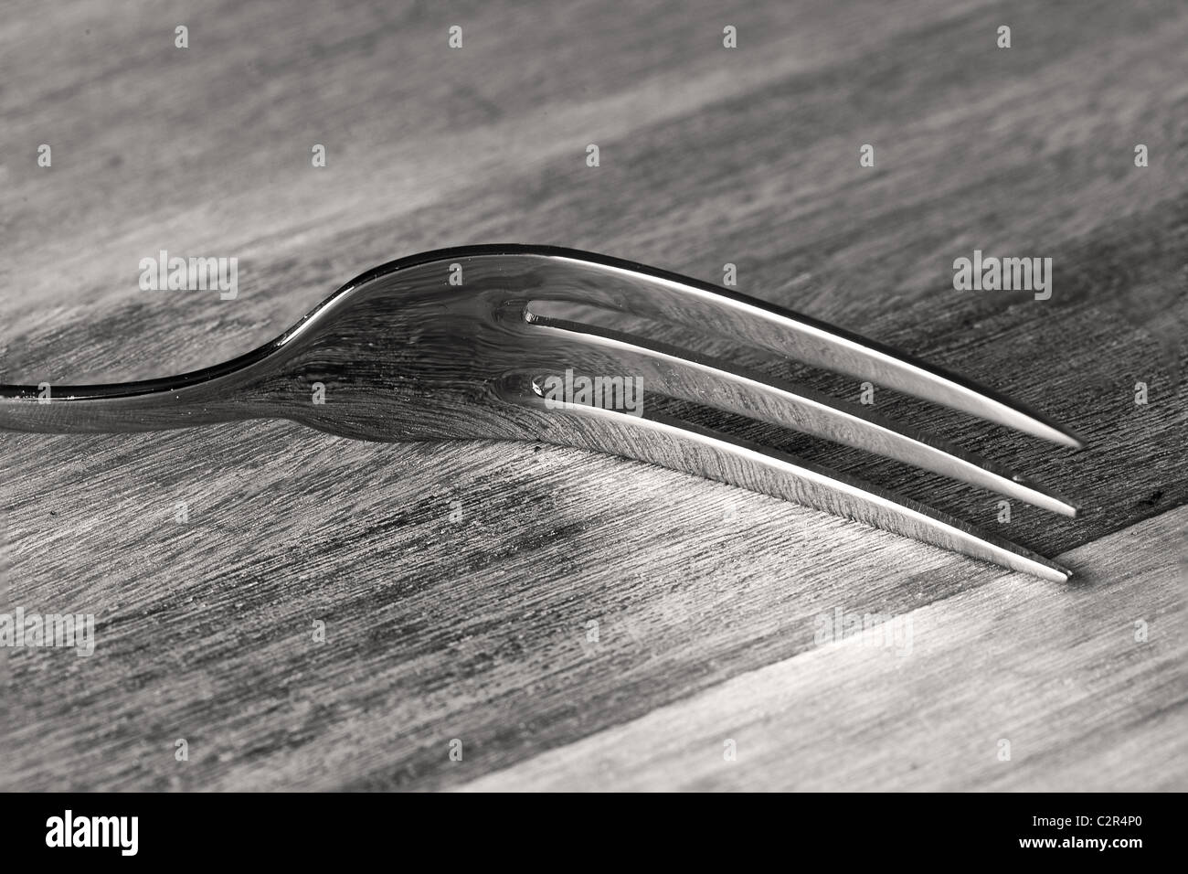 Steel Fork on wooden Table Stock Photo - Alamy
