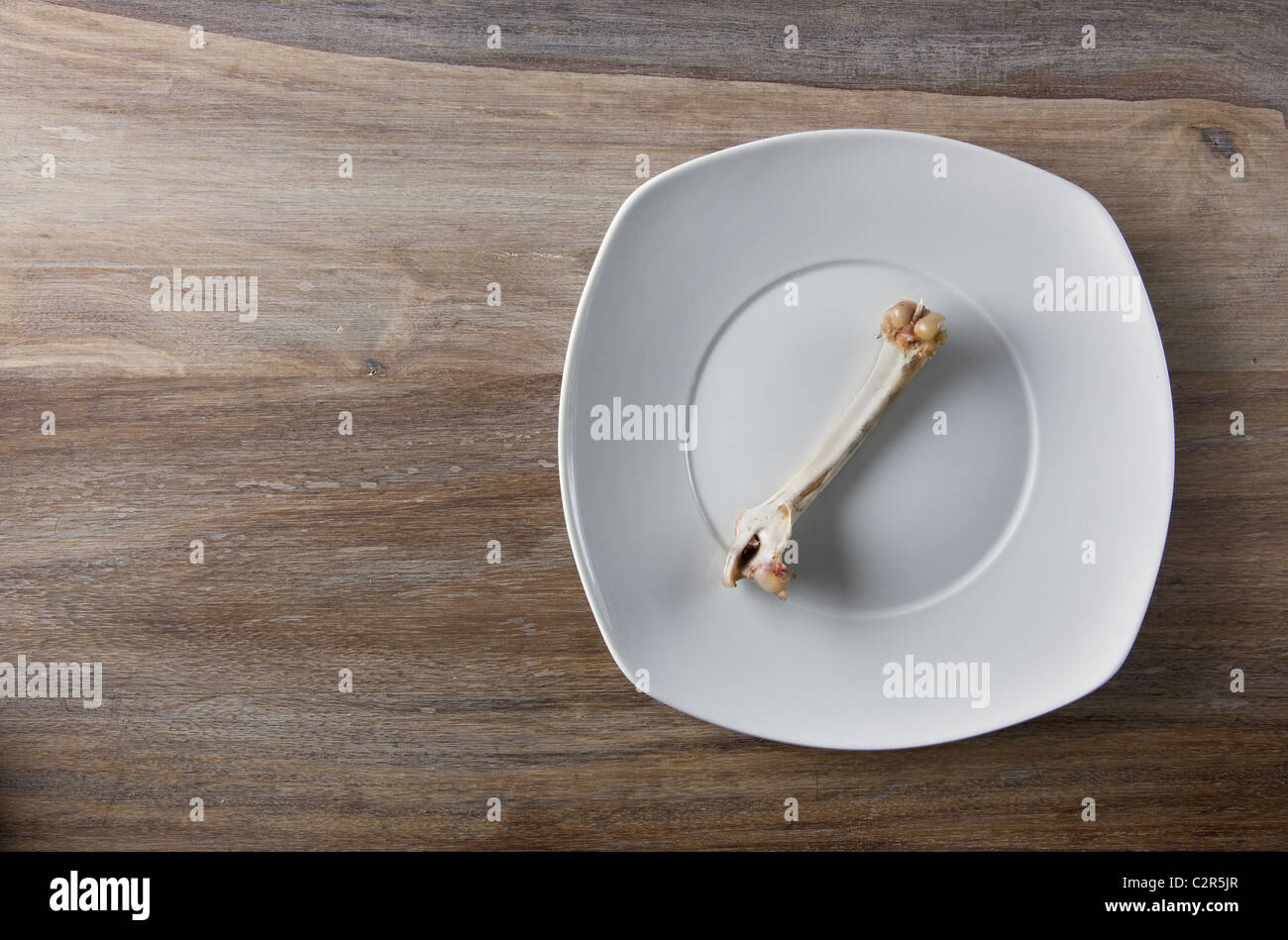 Empty dinner plate with bones Stock Photo - Alamy