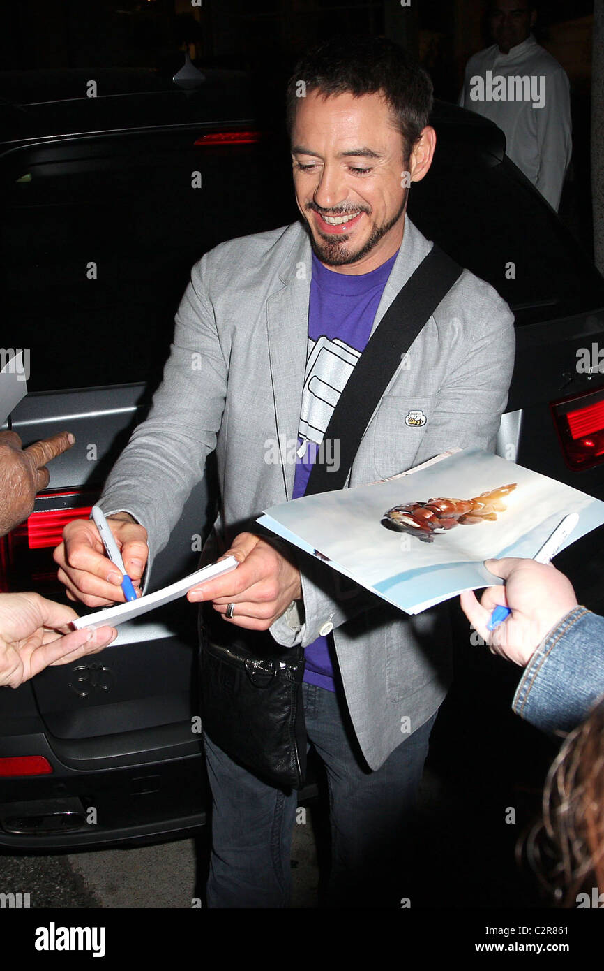 Robert Downey Jr signs autographs while leaving Mr Chow restaurant ...