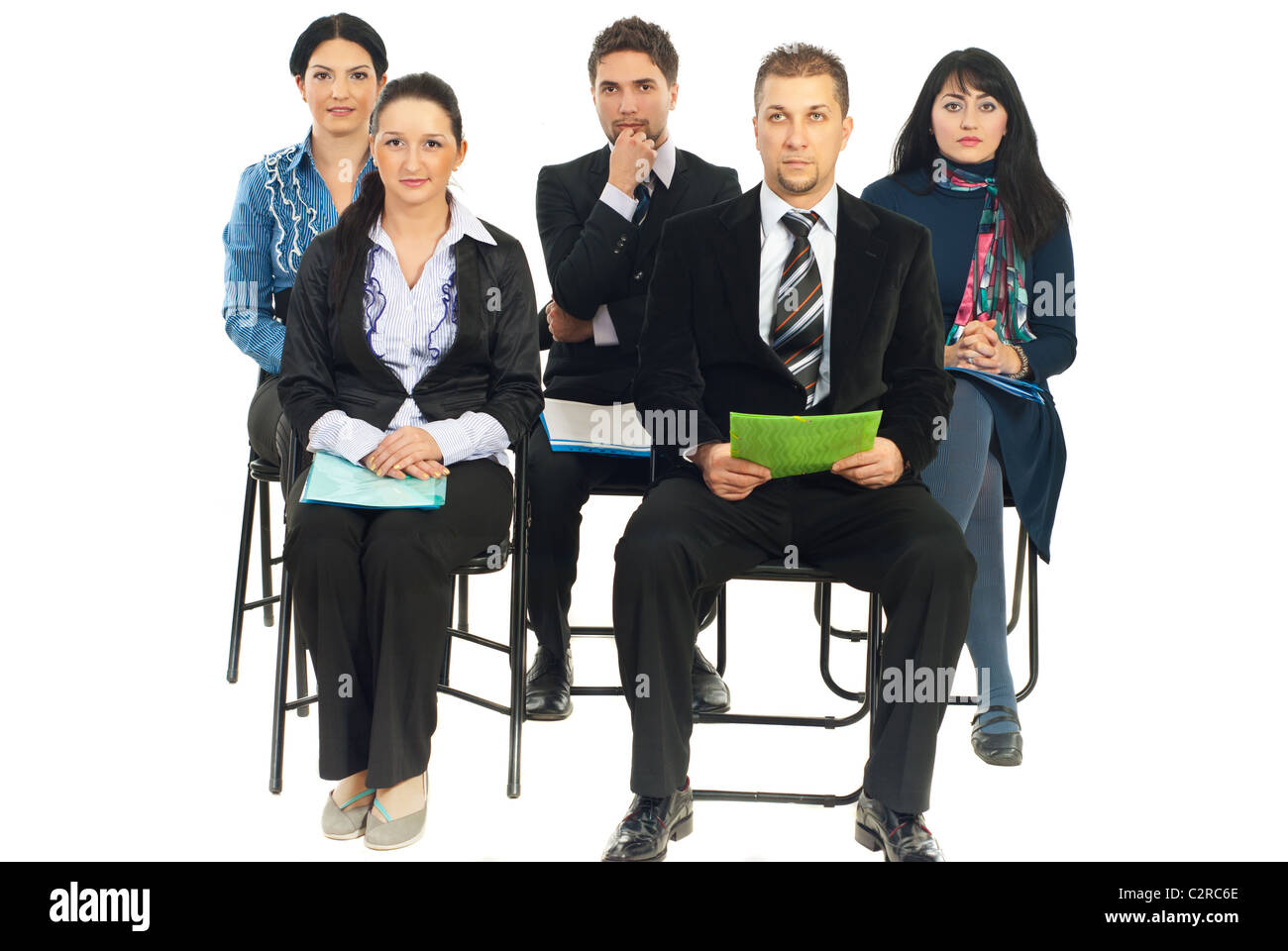 Five business people sitting on chair and listening at conference ...