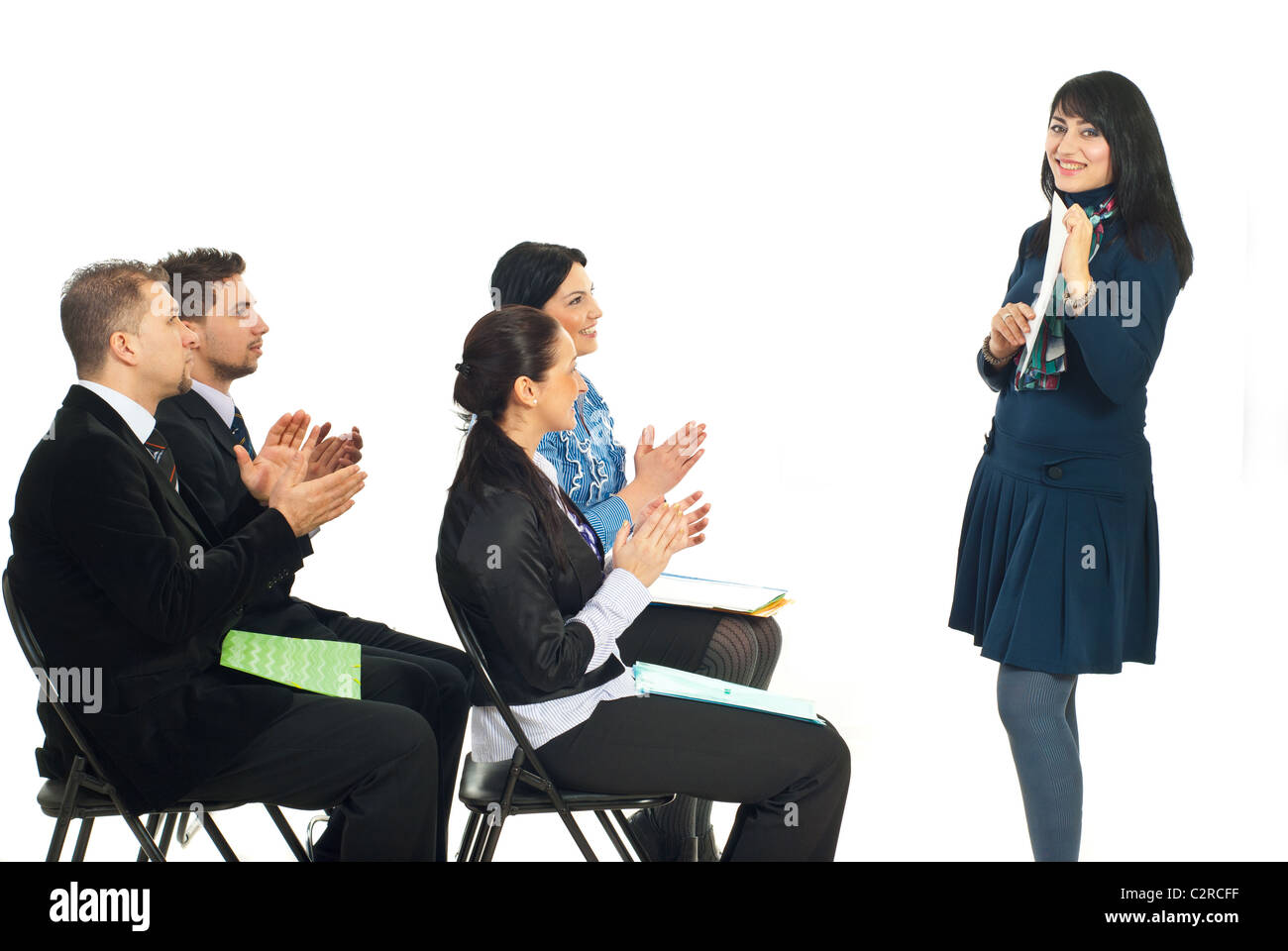 Executive woman receiving congratulations from her colleagues on chairs ...