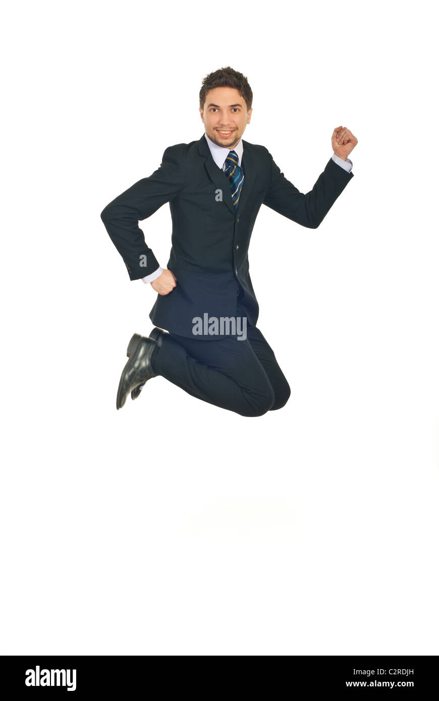 Successful young business man jumping isolated on white background ...