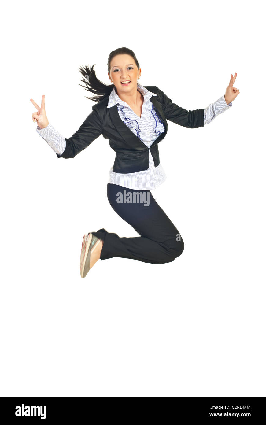 Victorious business woman jumping and showing victory sign hand gesture ...