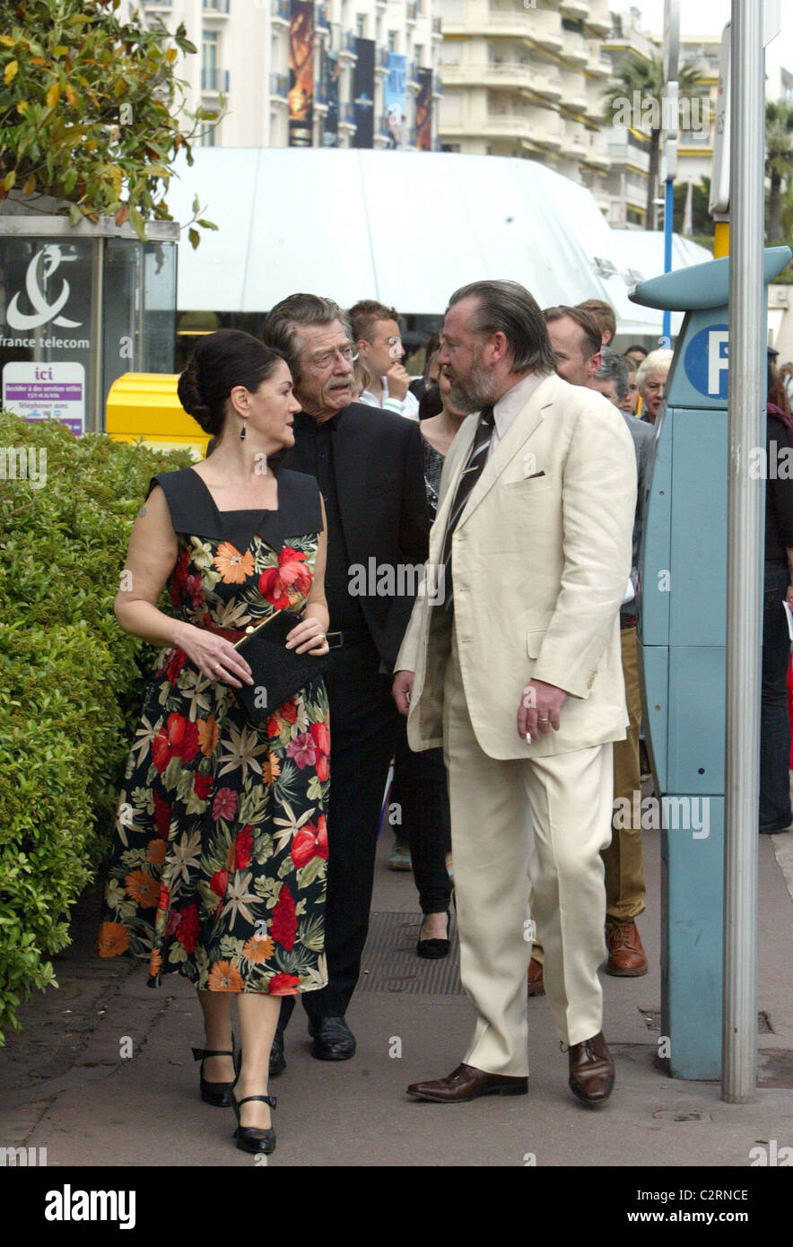 Ann Rees Meyers, John Hurt and Ray Winstone walk along the Croisette ...