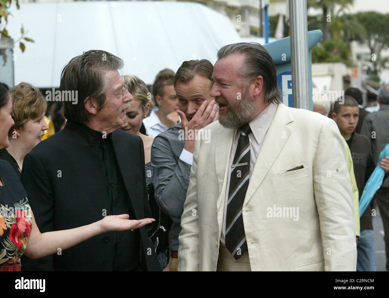Ann Rees Meyers, John Hurt and Ray Winstone walk along the Croisette ...