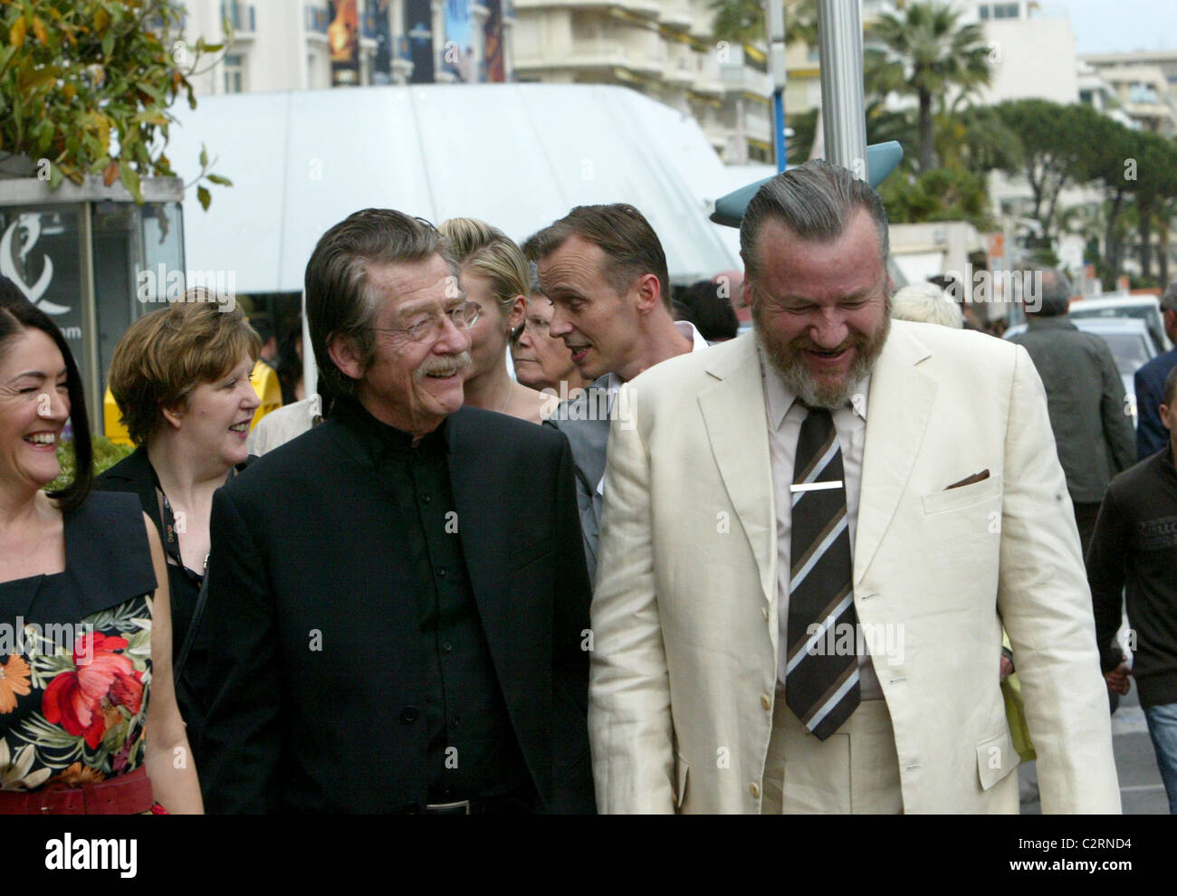 Ann Rees Meyers, John Hurt and Ray Winstone walk along the Croisette ...