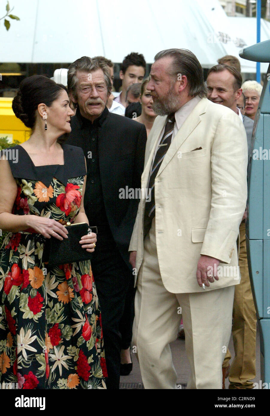 Ann Rees Meyers, John Hurt and Ray Winstone walk along the Croisette ...