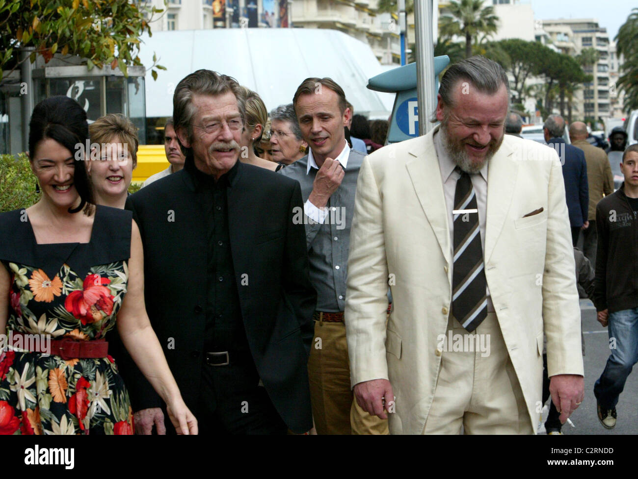 Ann Rees Meyers, John Hurt and Ray Winstone walk along the Croisette ...