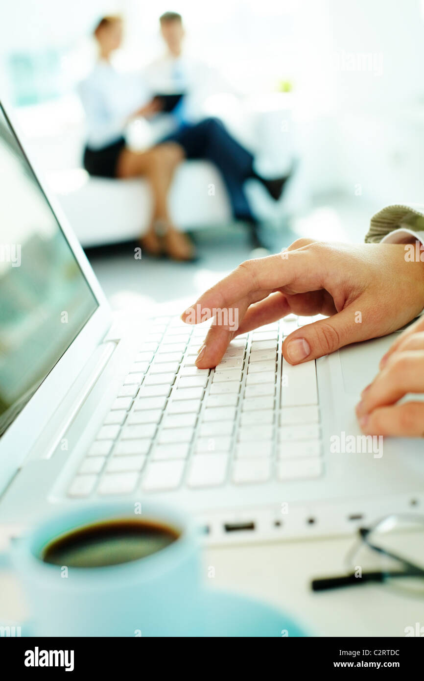 Human hand touching keyboard buttons in working environment Stock Photo ...