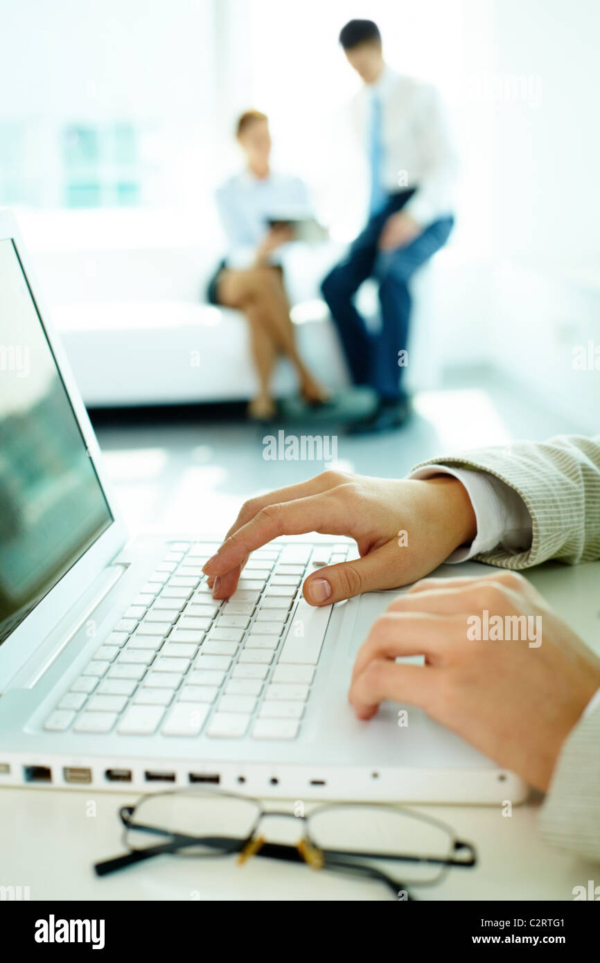 Human hand touching keyboard buttons in working environment Stock Photo ...