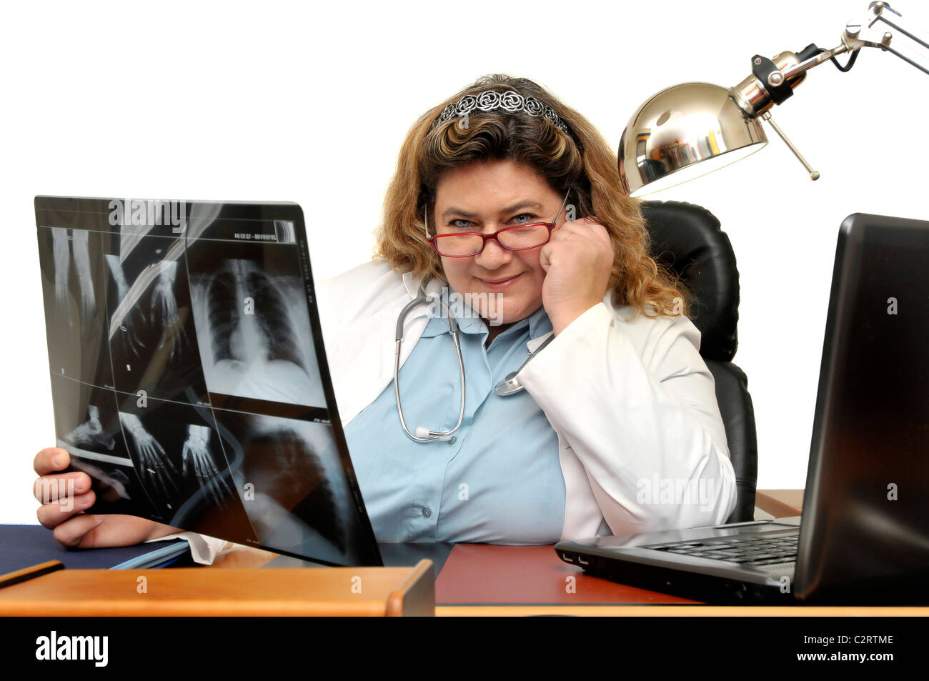 Doctor at the desk with X-ray Stock Photo - Alamy