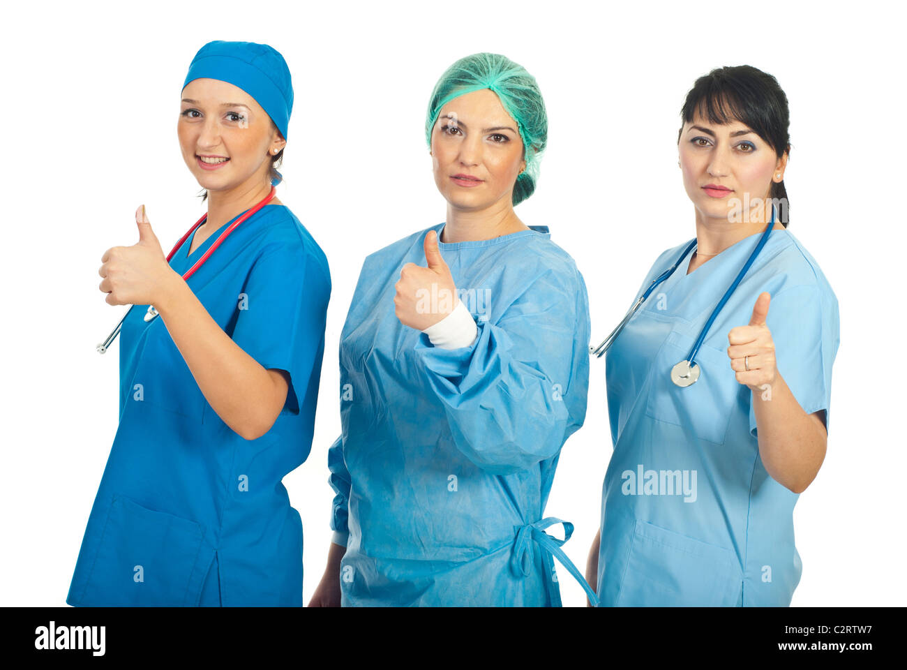 Three doctors women standing in a row and giving thumbs up isolated on ...