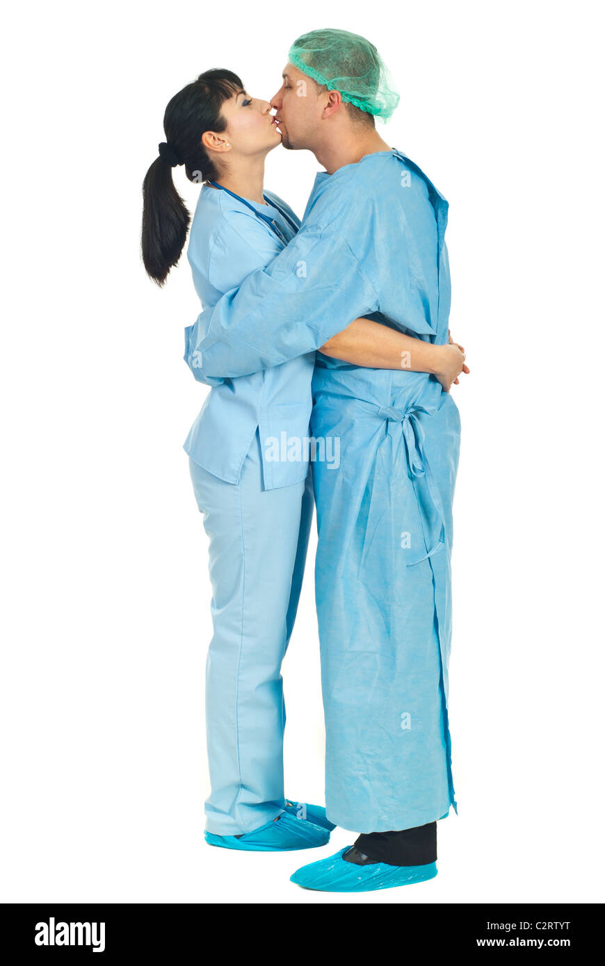 Full length of couple of doctors in uniforms kissing isolated on white ...
