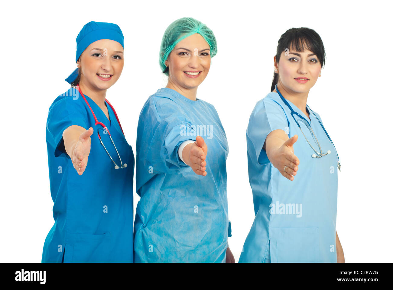 Three different doctors women standing in a row with their hands ...