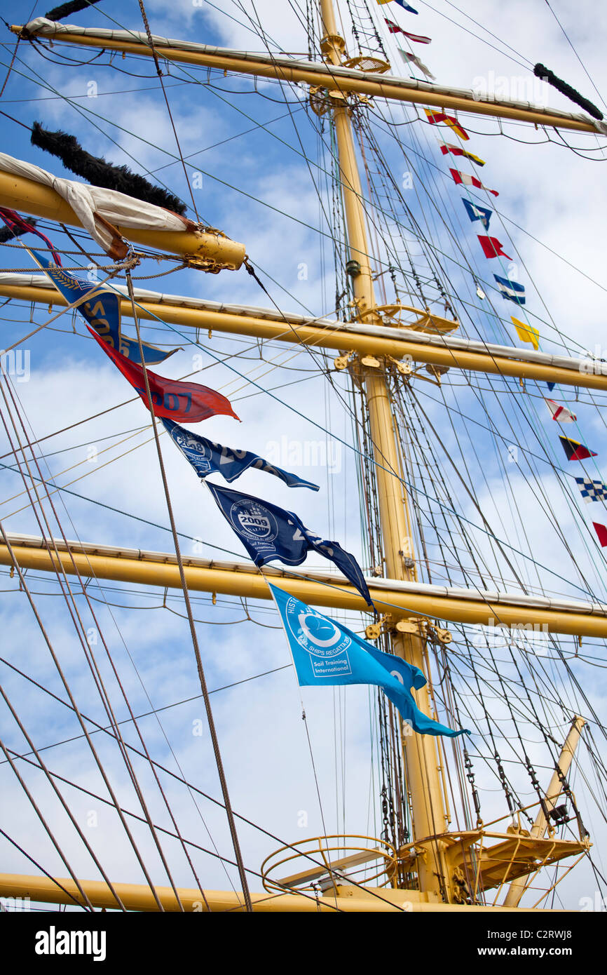 The masts of a tall sailing ship complete with all of the pennants ...