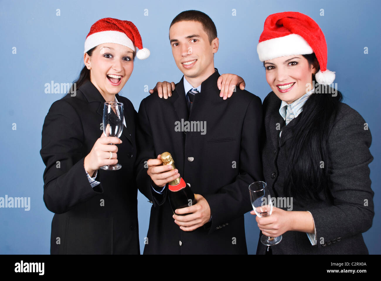 Business people celebrate Christmas with champagne and wearing Santa ...