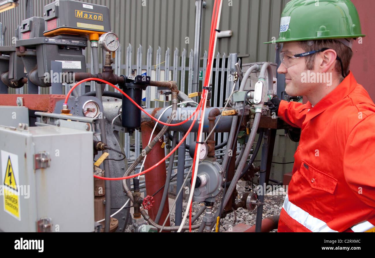 Industrial waste treatment plant, England - worker at controls Stock ...