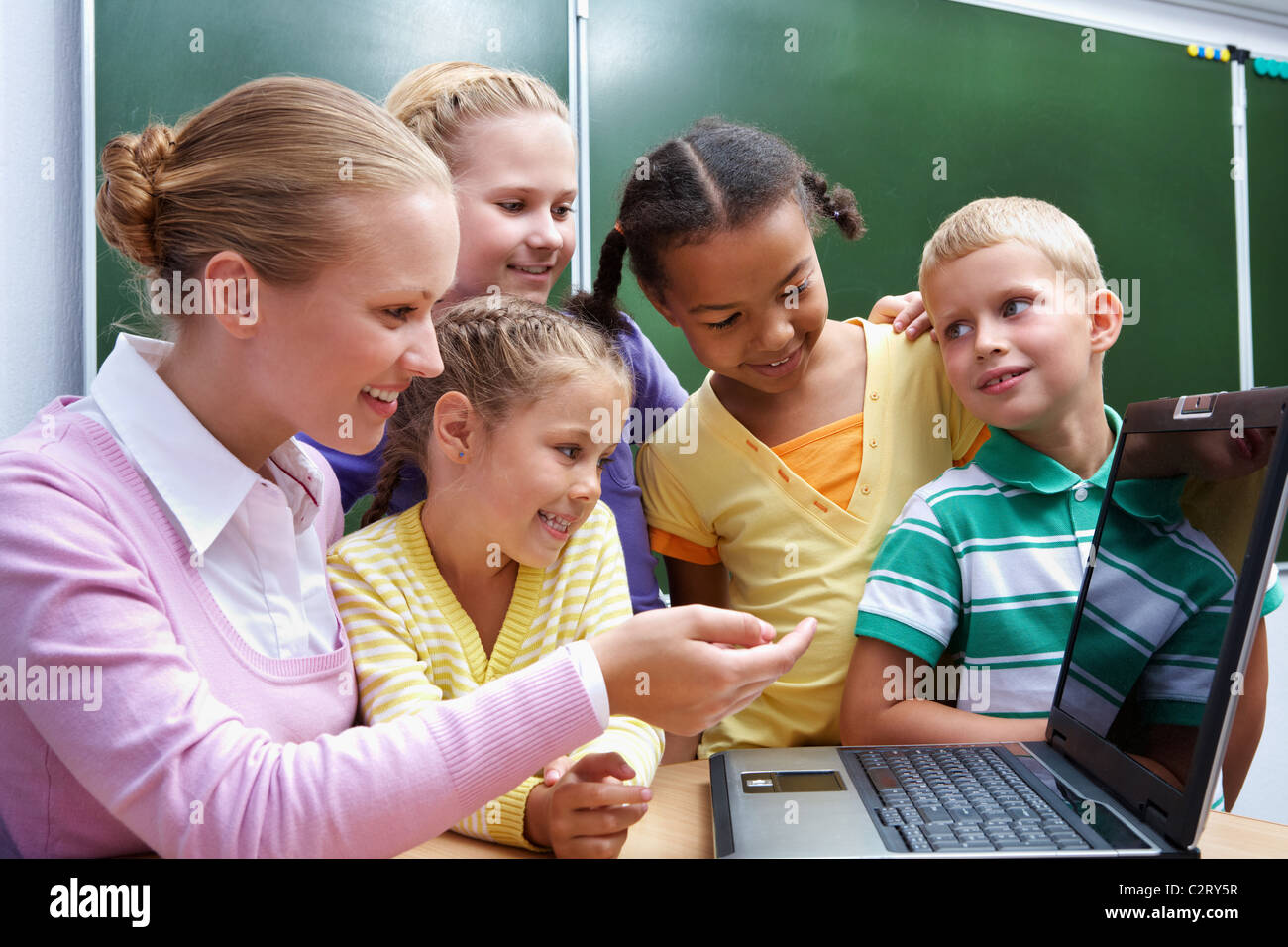 Portrait of smart pupils sitting in the classroom and looking at camera ...