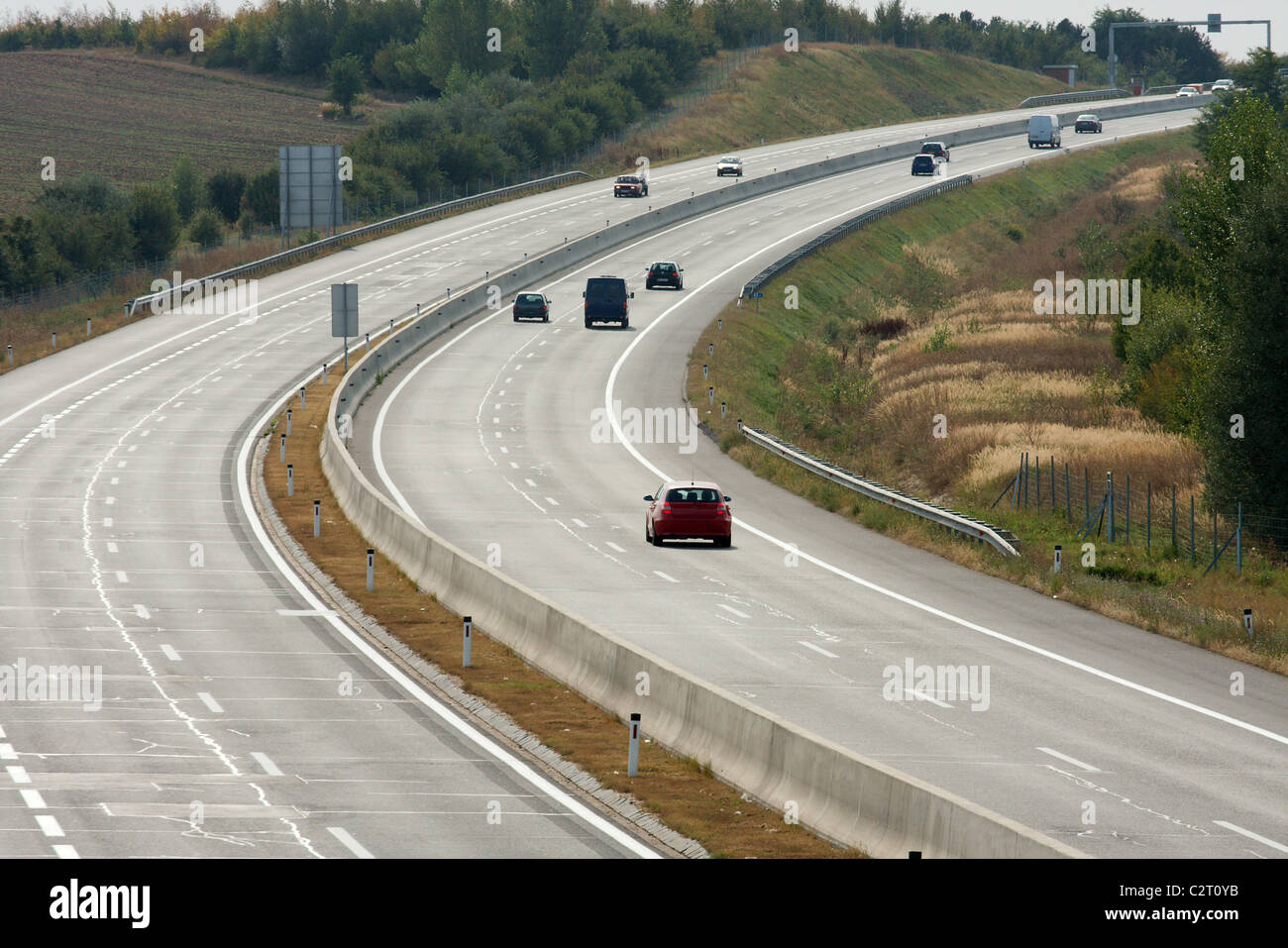 Bending highway with some car passing by Stock Photo - Alamy