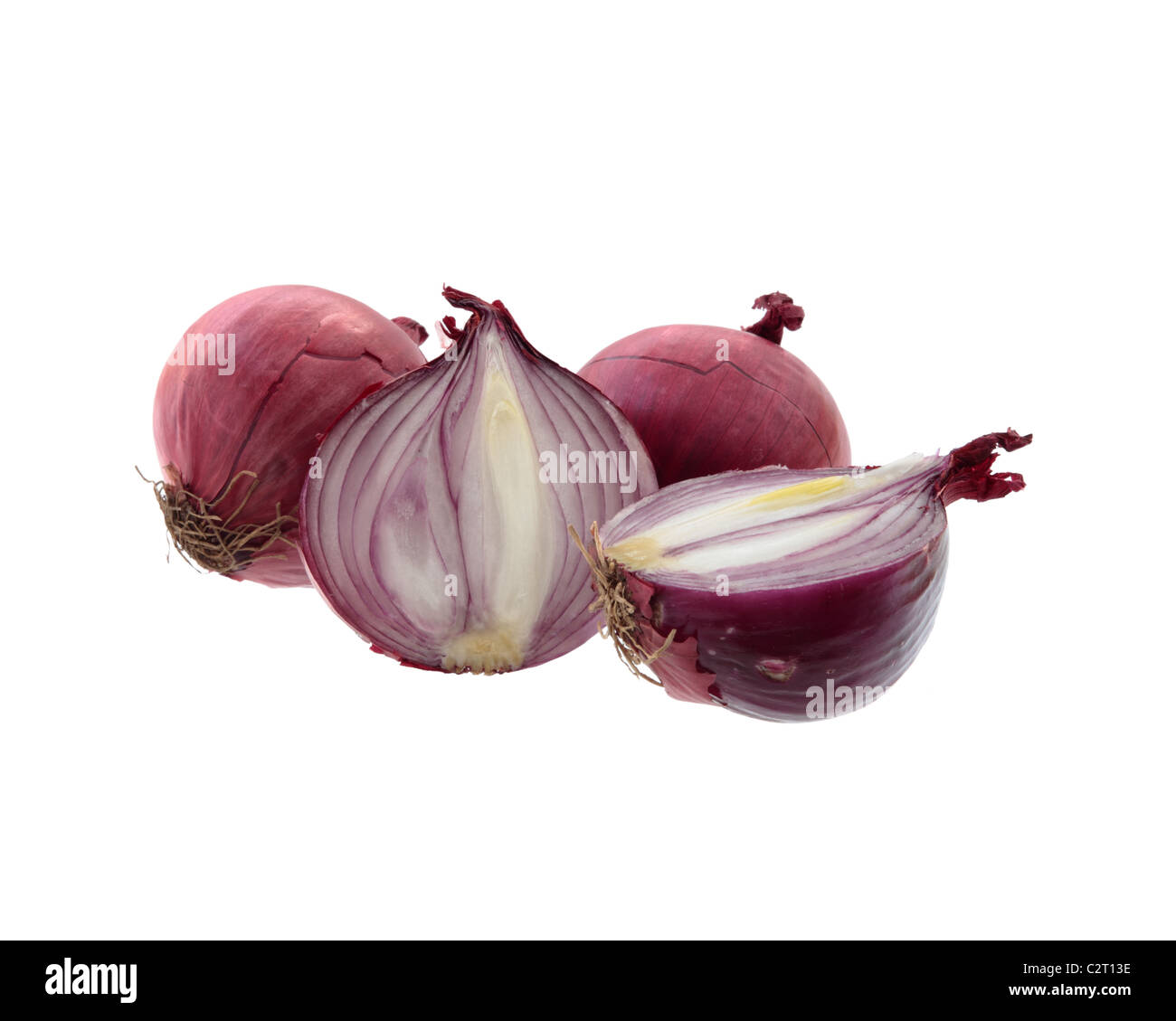 Three red onions one sliced in half, isolated on a white background ...