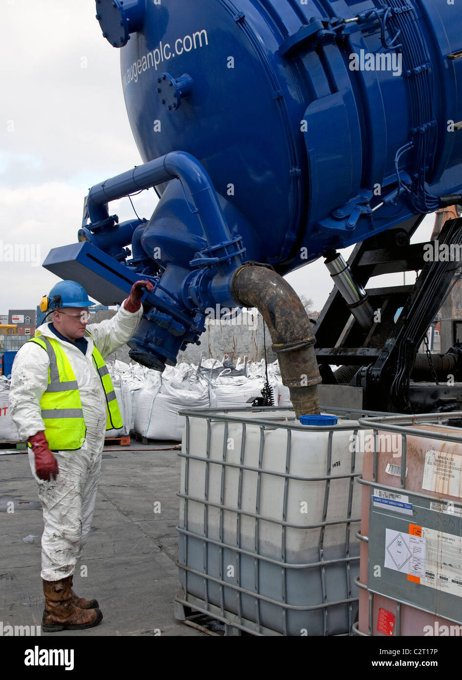 Industrial waste treatment plant, England: filling containers from ...