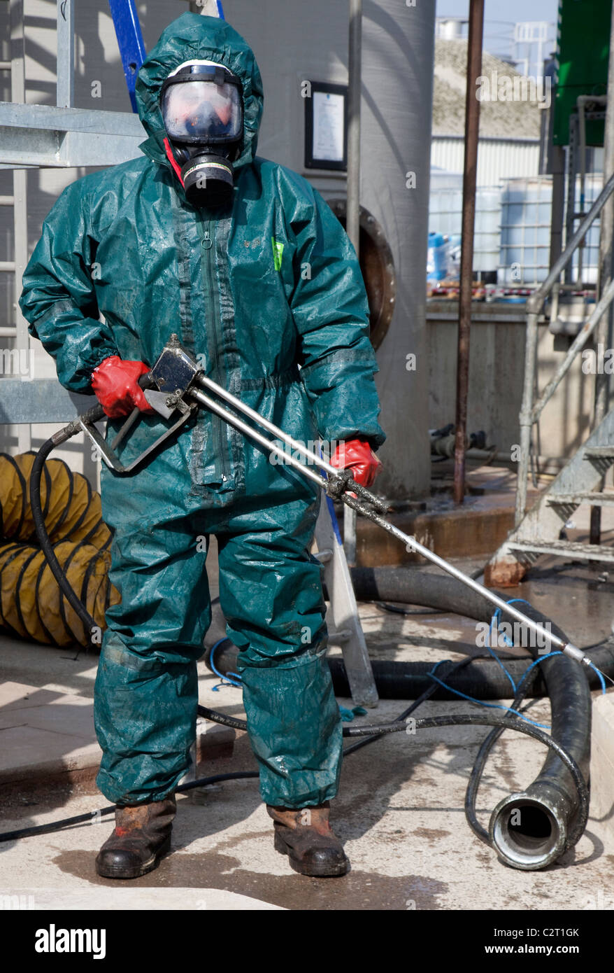 Industrial waste treatment plant, England - worker with protective ...