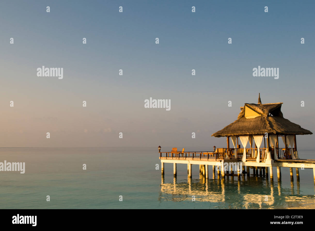 Gazebo and jetty with straw roof at a resort in the Maldives Stock ...
