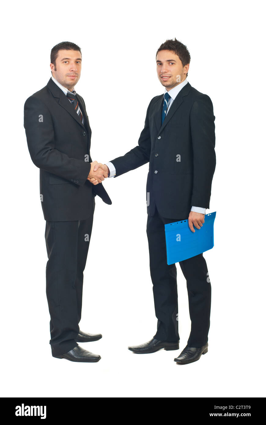 Full length of two business men shaking hands and one of them holding a ...