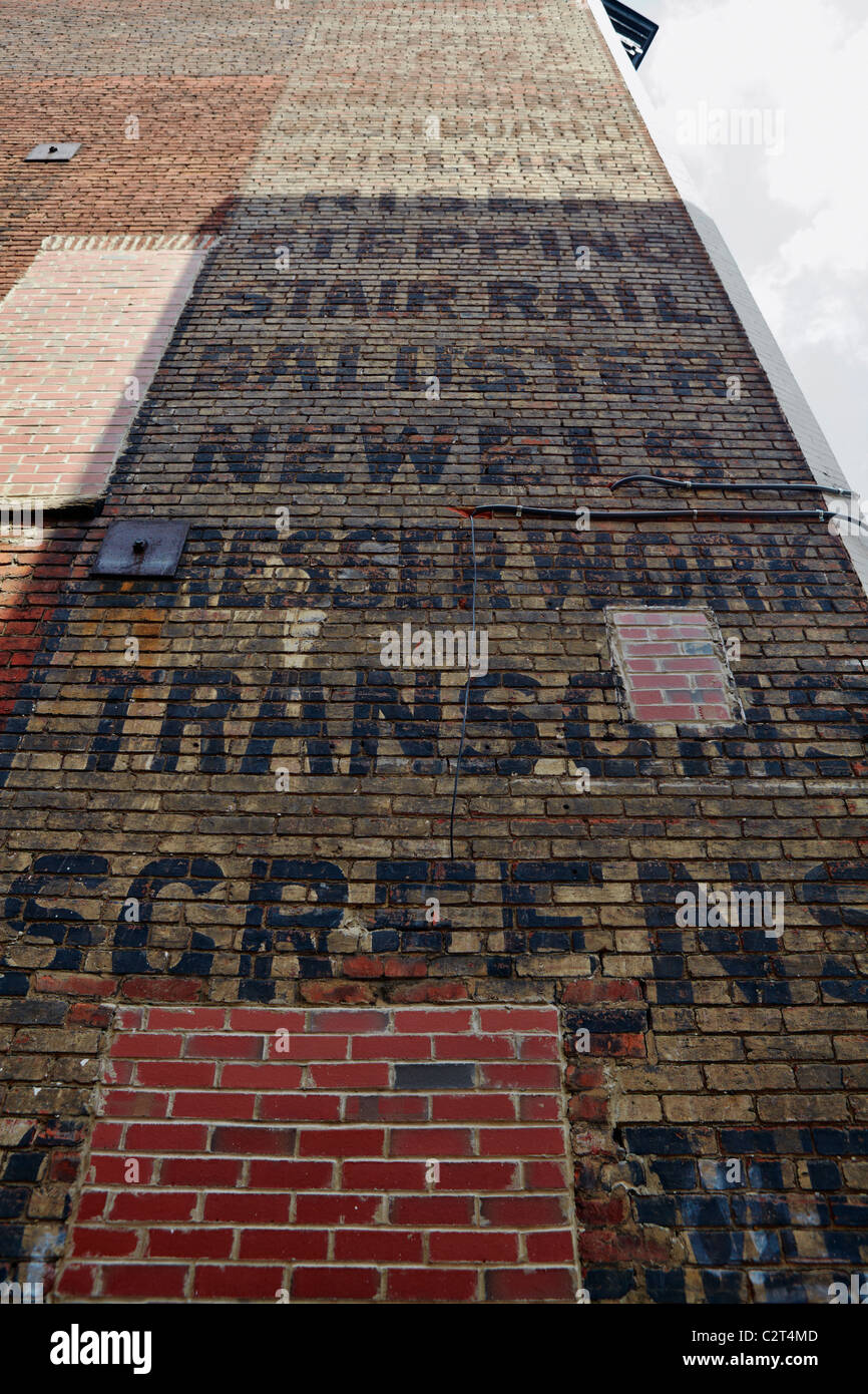 Vintage painted commercial sign on the side of a brick building in ...
