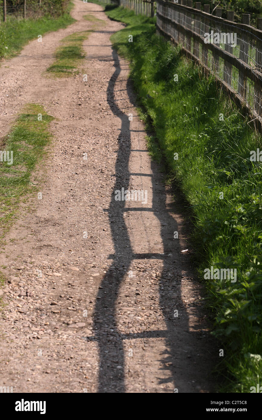 Country lane with wooden fence and shadow Stock Photo - Alamy