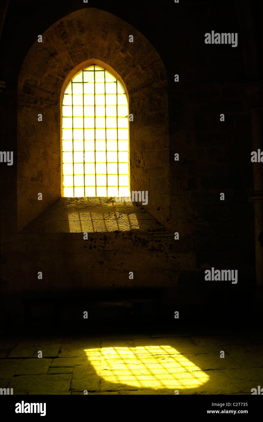 Sunshine shines through an arched church window Stock Photo - Alamy
