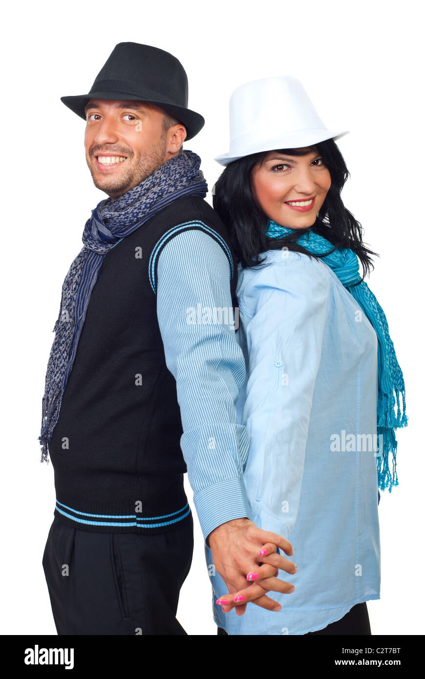 Happy couple standing back to back and holding their hands isolated on ...