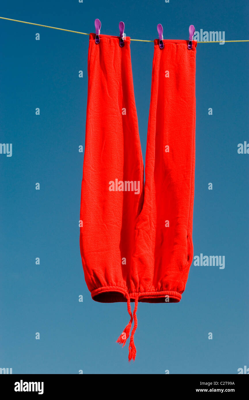 bright red trousers on washing line against a bright blue sky Stock ...