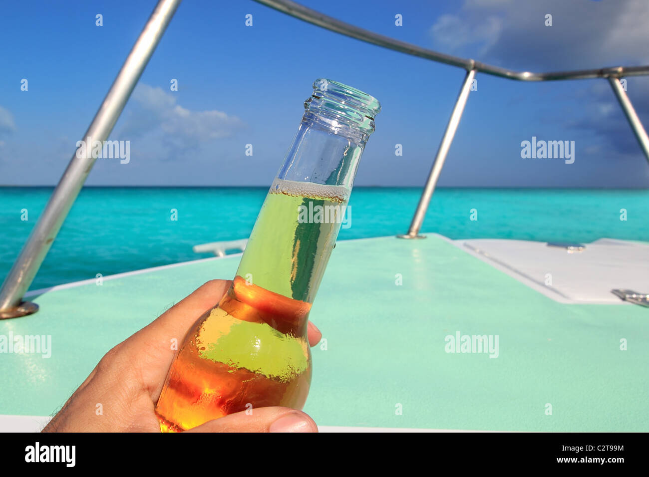 beer on hand Caribbean in boat bow turquoise sea enjoying vacation ...