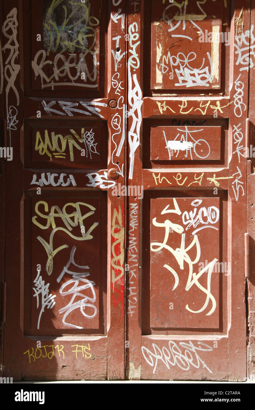lots of covered graffiti on wooden door Stock Photo - Alamy