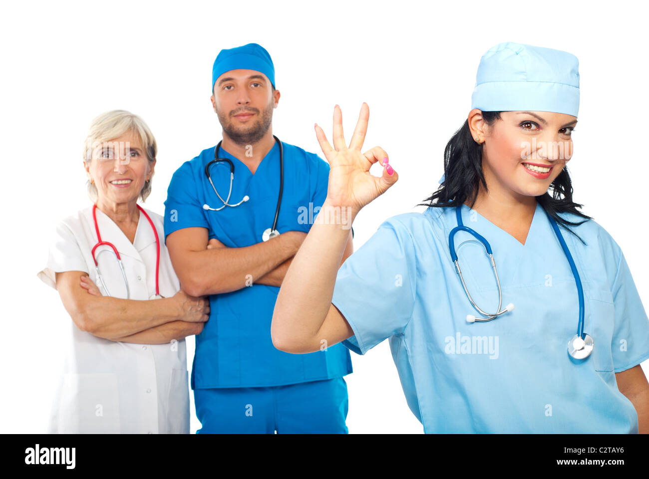 Doctor woman showing okay sign while her team standing with hands ...