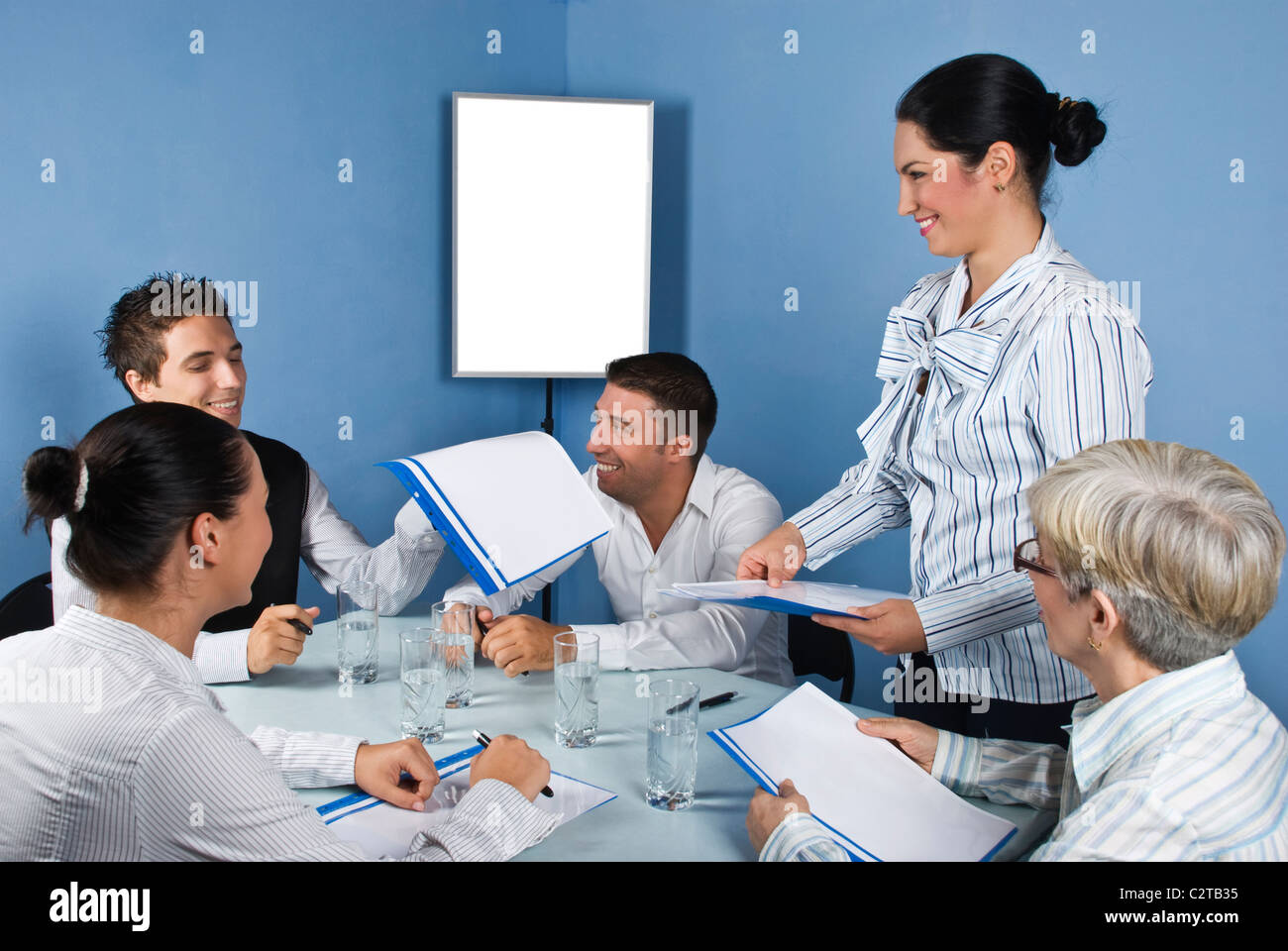 Group of people at meeting having fun and laughing while a business ...