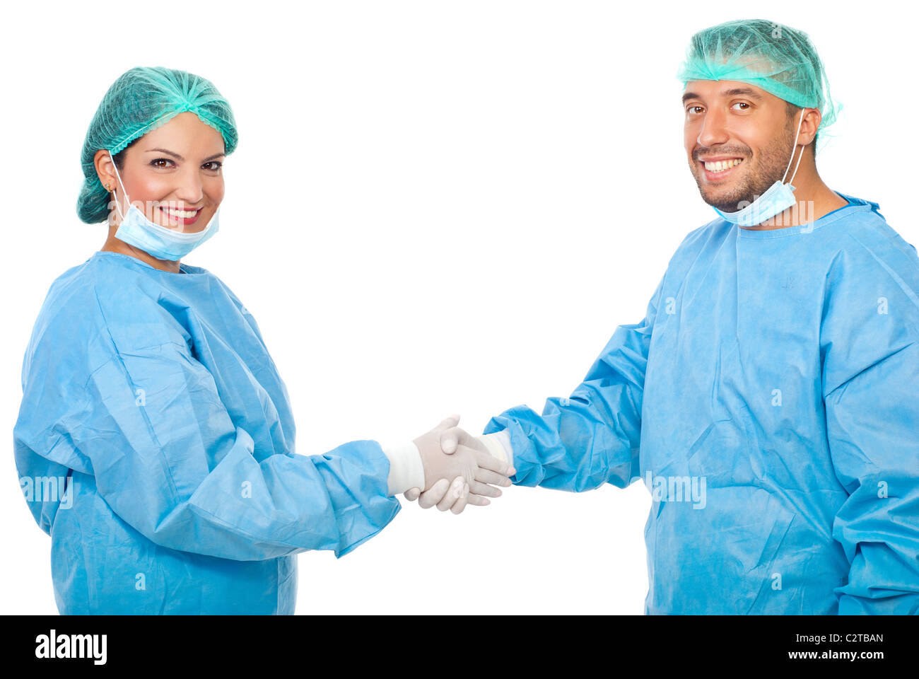 Two happy surgeons team shaking hands and smiling isolated on white ...