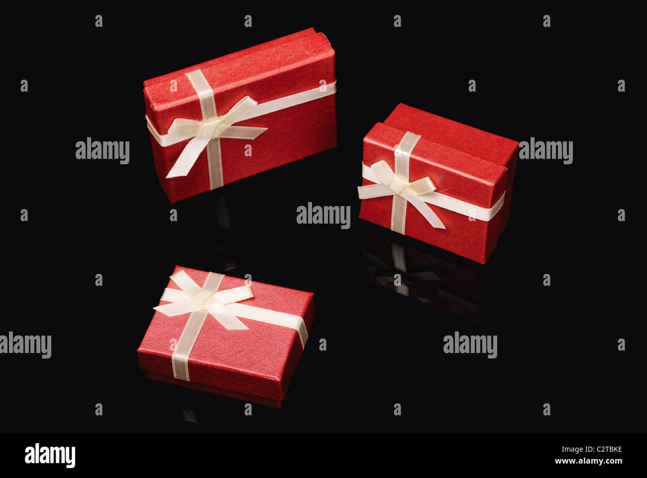 red gift boxes on black Stock Photo - Alamy