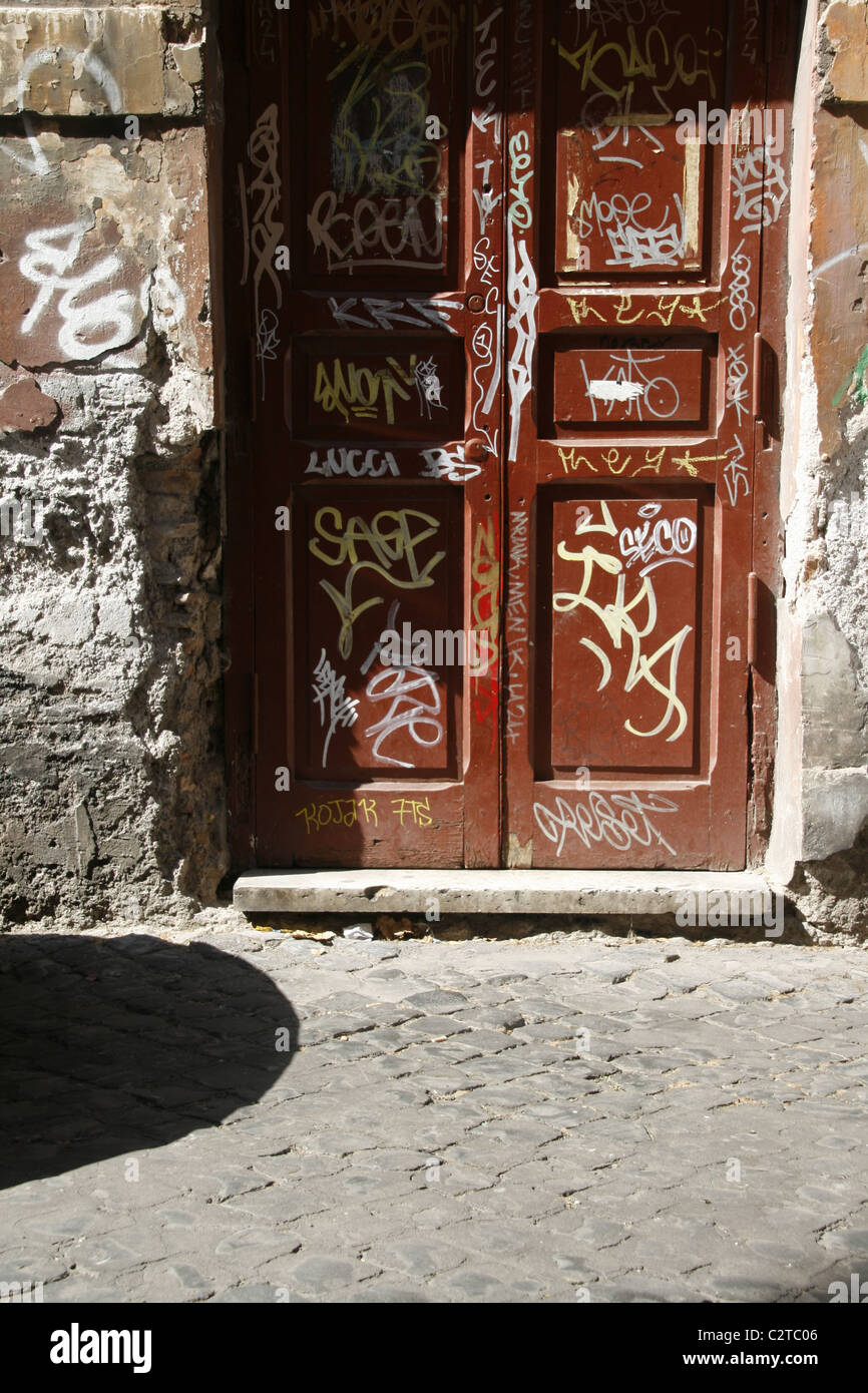 lots of covered graffiti on wooden door Stock Photo - Alamy
