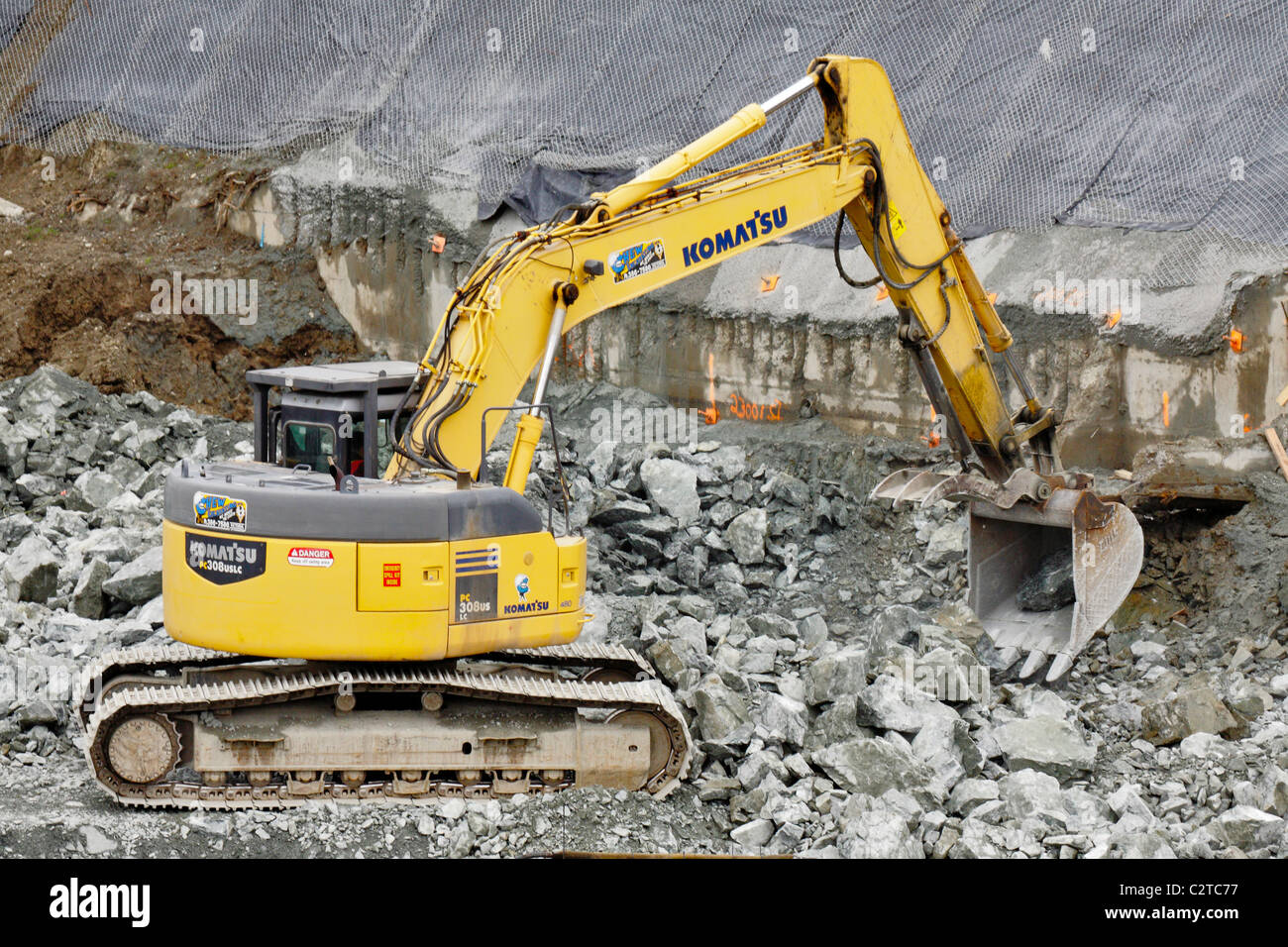 Excavator moving large rocks on construction site-Victoria, British ...
