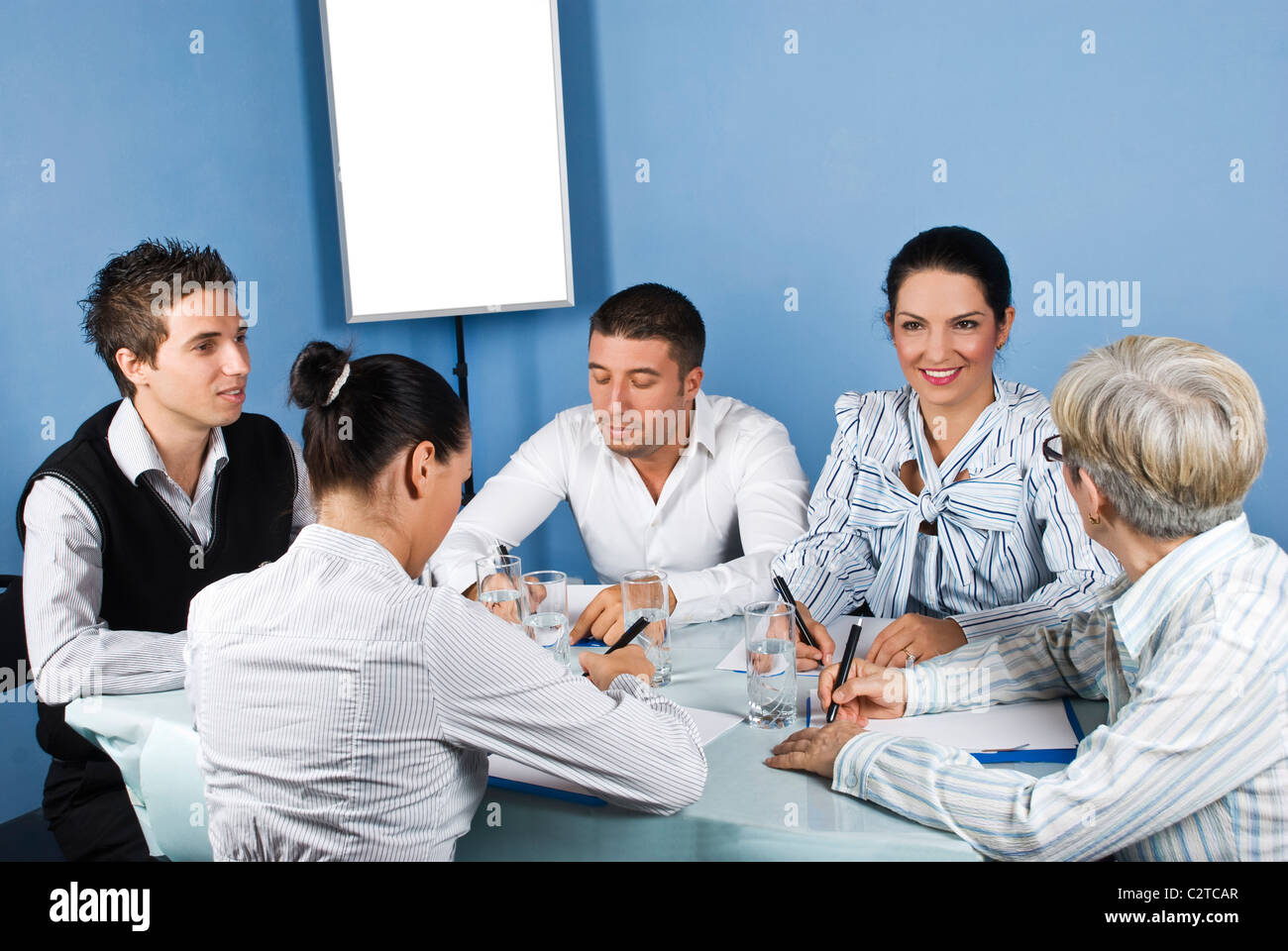 Happy group of people have an conversation at business meeting in ...